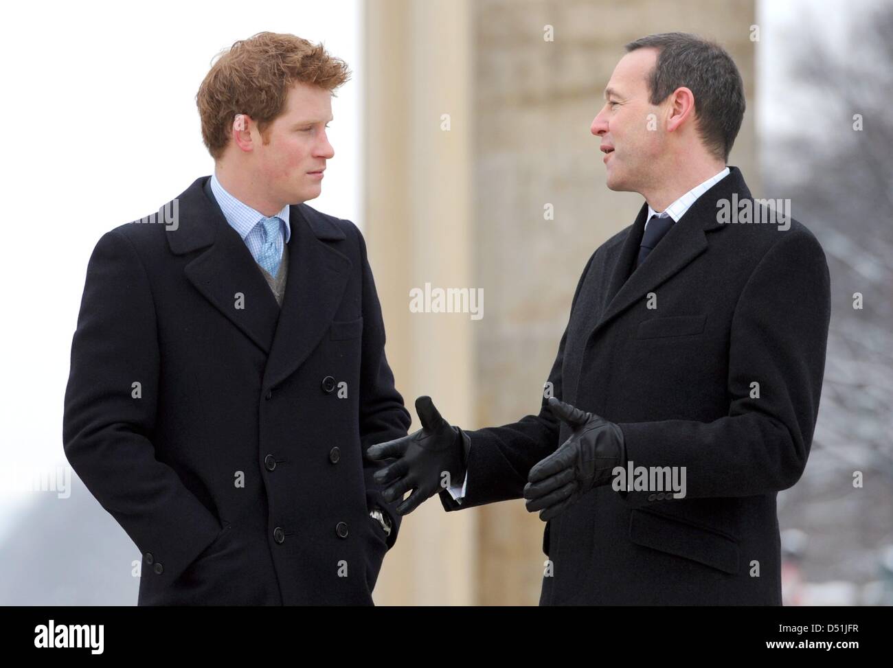 British Prince Harry (L) stands in front of the Brandenburg Gate with ...