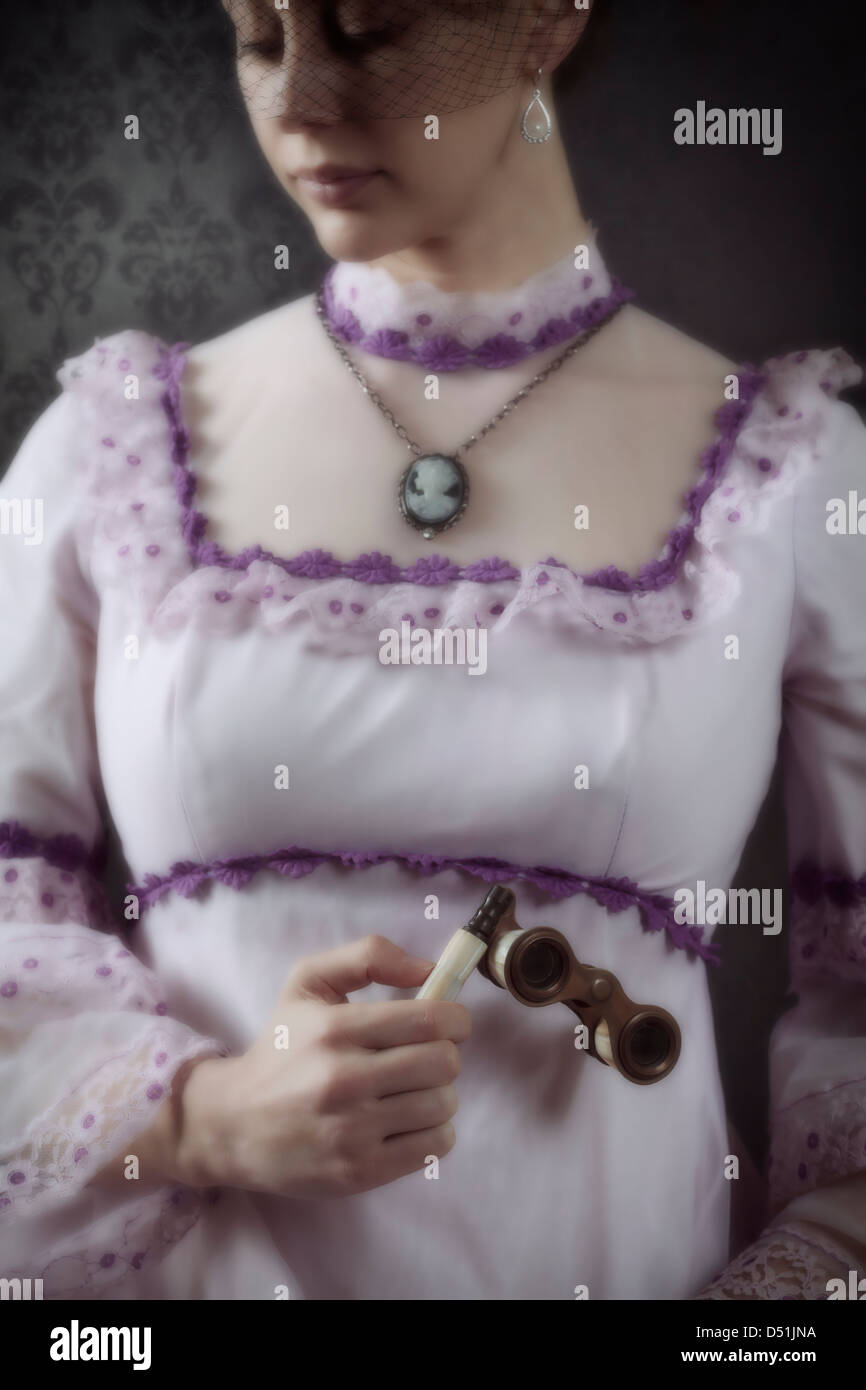 an elegant lady in a pink dress with a veil hat and lorgnette Stock ...