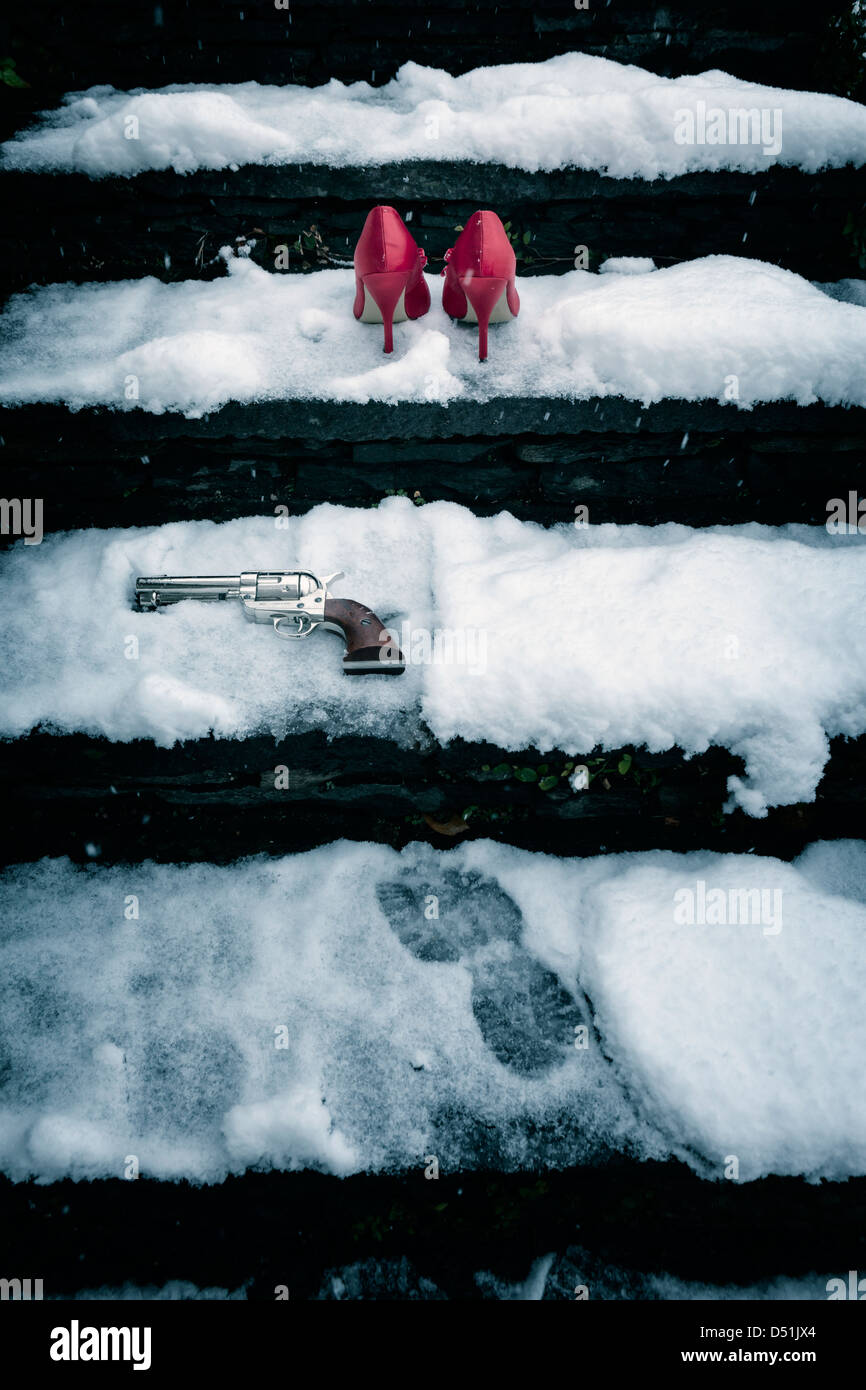 red high heels on snow-covered stairs with a male footprint and a gun ...