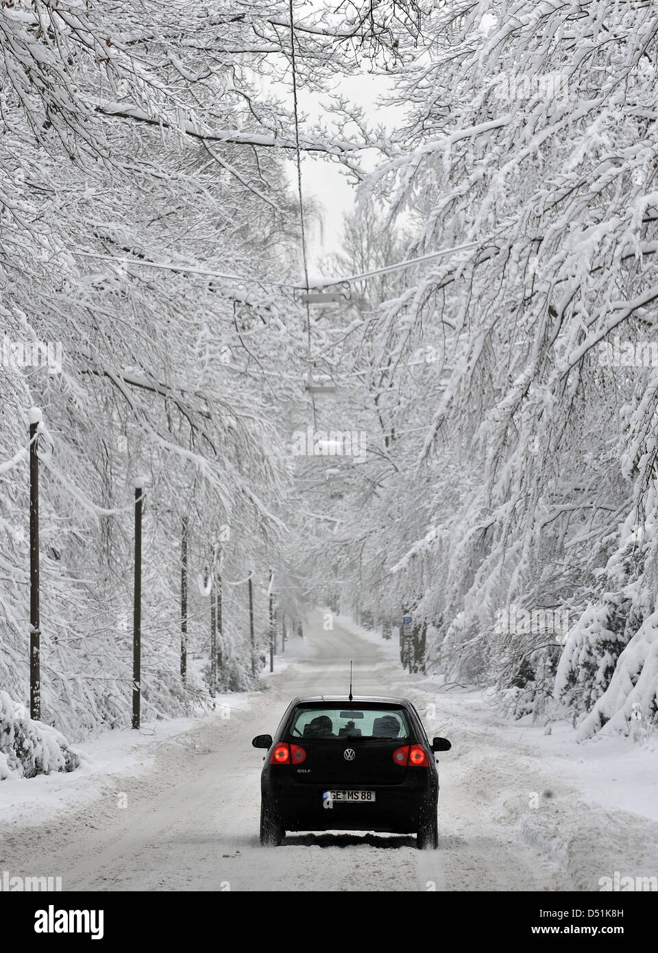 A car passes a snowed street in Gelsenkirchen, Germany, 20 December ...