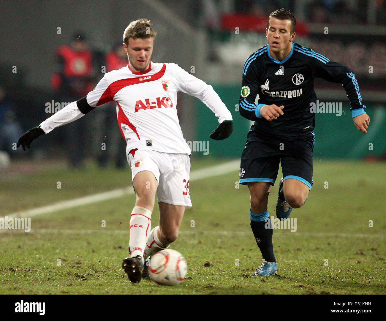 Schalke's Lukas Schmitz and Augsburg's Stephan Hain vie for the ball ...