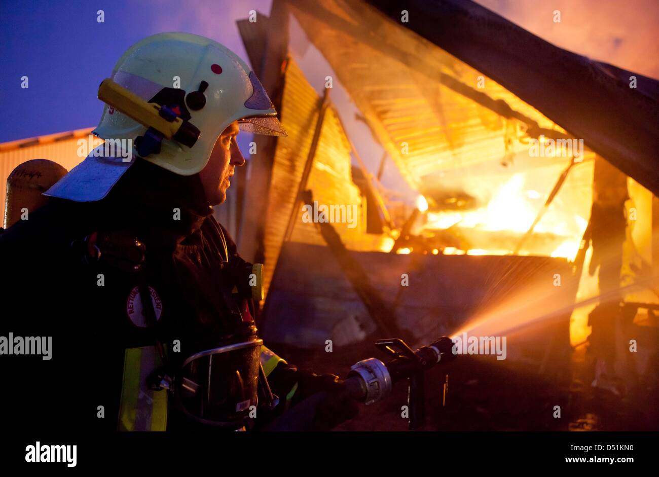 Firefighters extinguish a major fire in a carpenter's workshop in ...