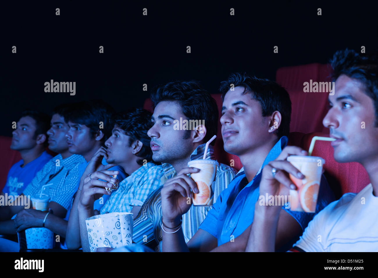 Youngsters enjoying movie in a cinema hall Stock Photo - Alamy