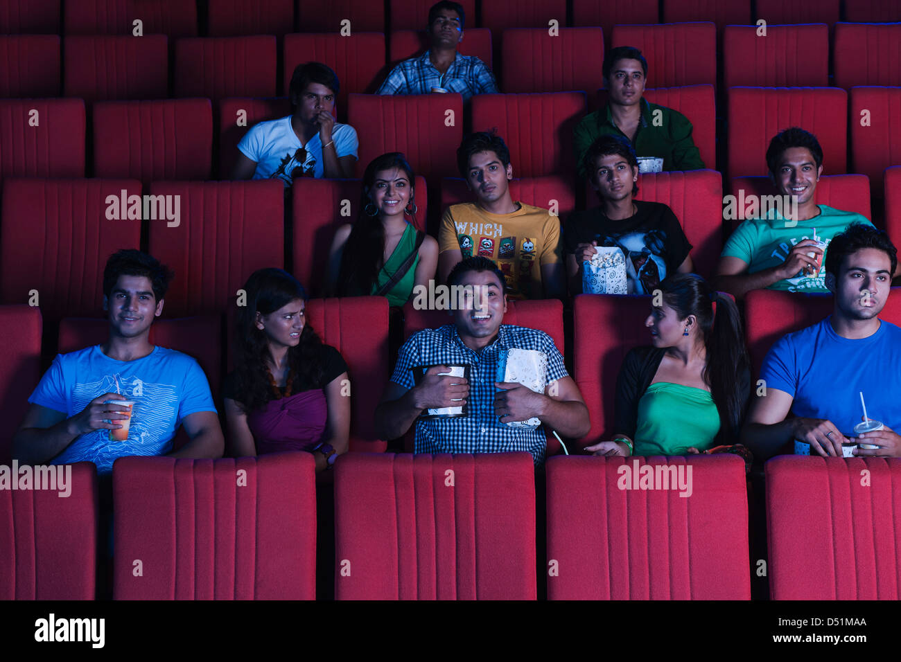 Youngsters enjoying movie in a cinema hall Stock Photo - Alamy