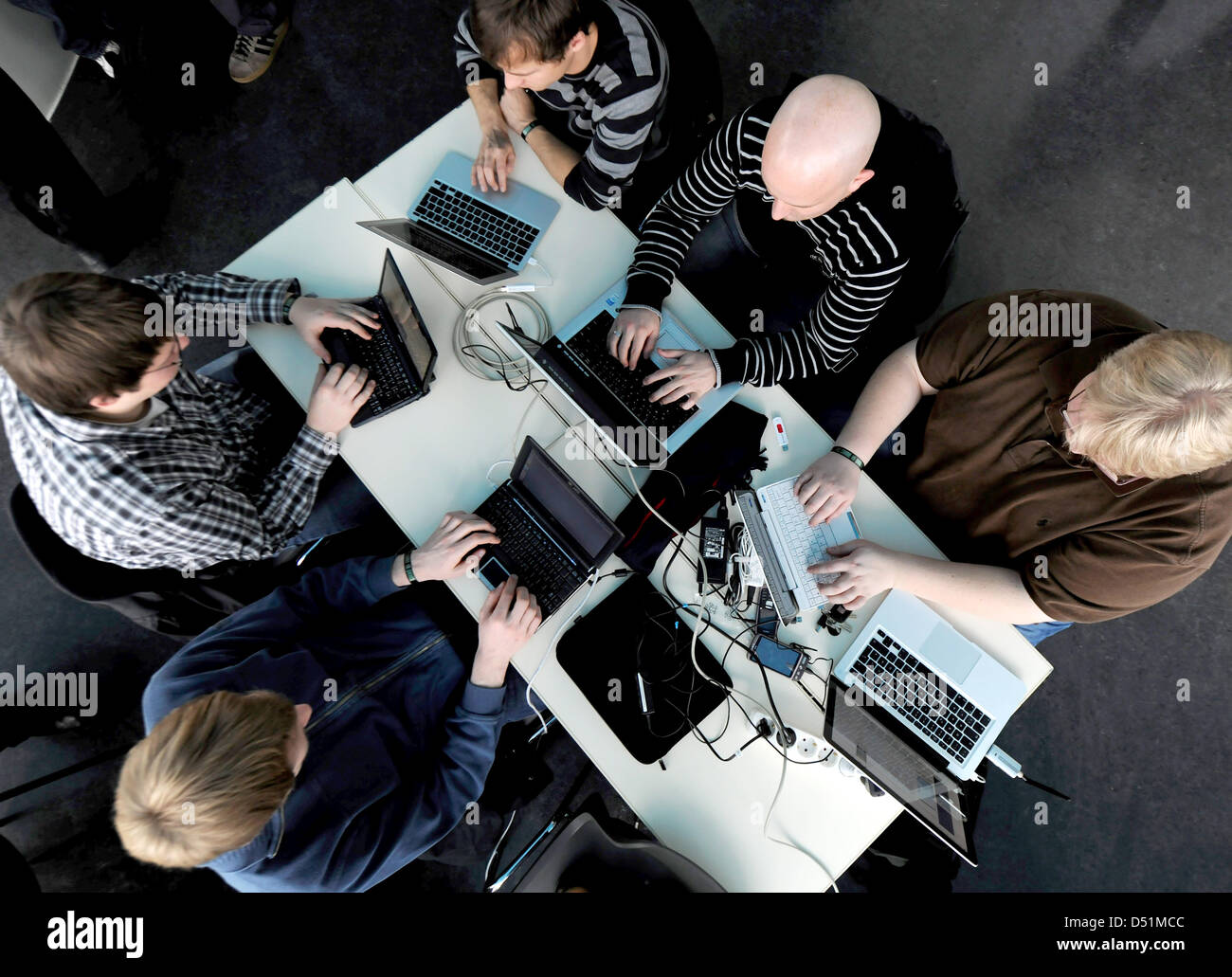 Visitors work on their notebooks during the 27th convention of the ...