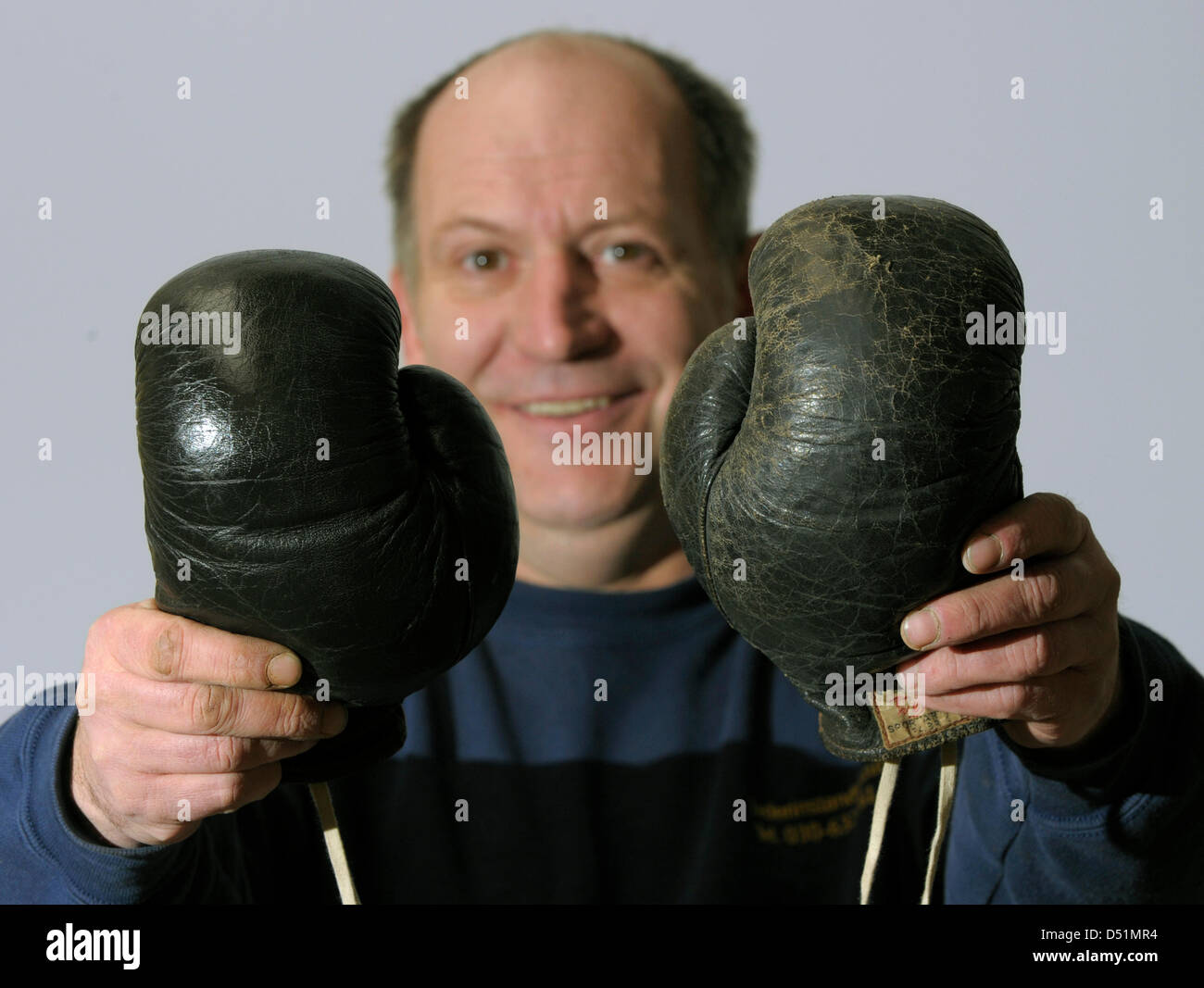 Tanner Uwe Dietrich presents a pair of boxing gloves, before ...
