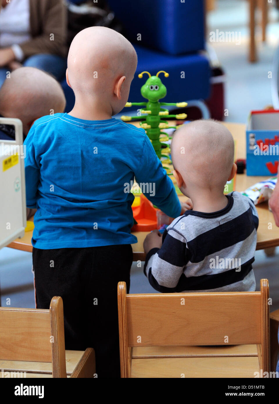 Three young children suffering from cancer play together in the ...