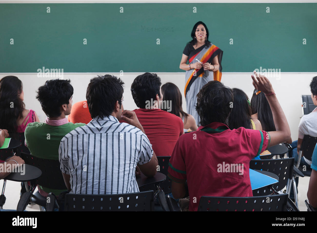 Female lecturer teaching in a classroom Stock Photo - Alamy
