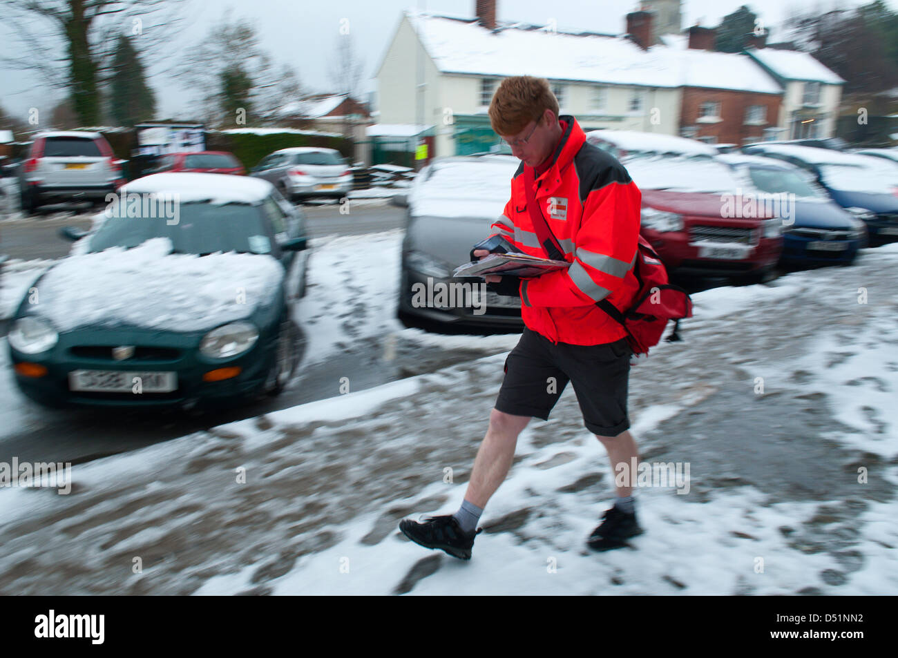 Montgomery, Wales, UK. 22nd March 2013. A postman wears shorts as he ...
