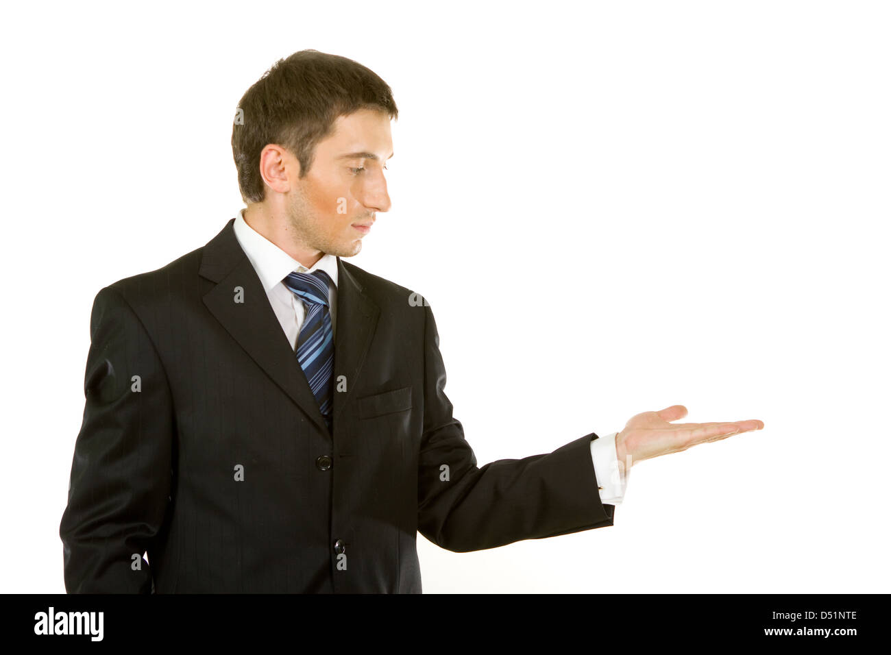 Handsome young man in a suit presenting or showing you something Stock ...