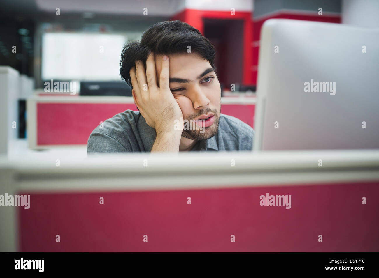Businessman looking at a computer Stock Photo - Alamy