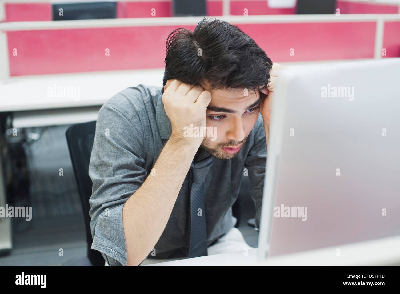 Businessman looking at a computer Stock Photo - Alamy