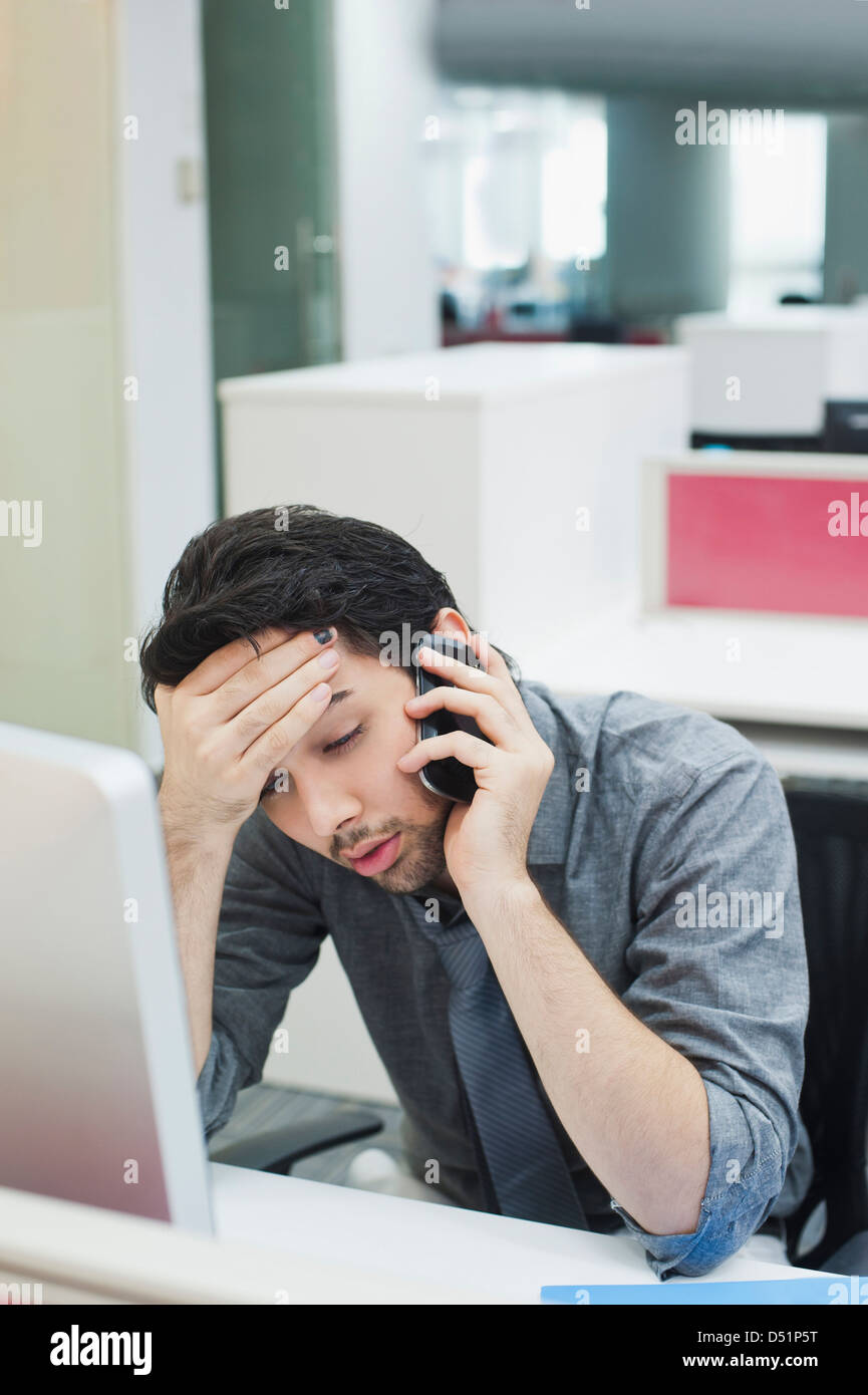 Tired businessman holding head listening hi-res stock photography and ...