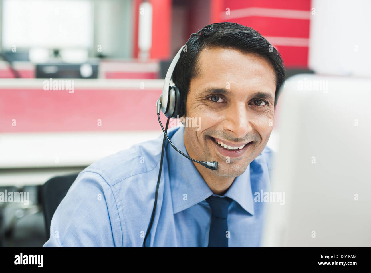 Customer service representative wearing a headset Stock Photo - Alamy
