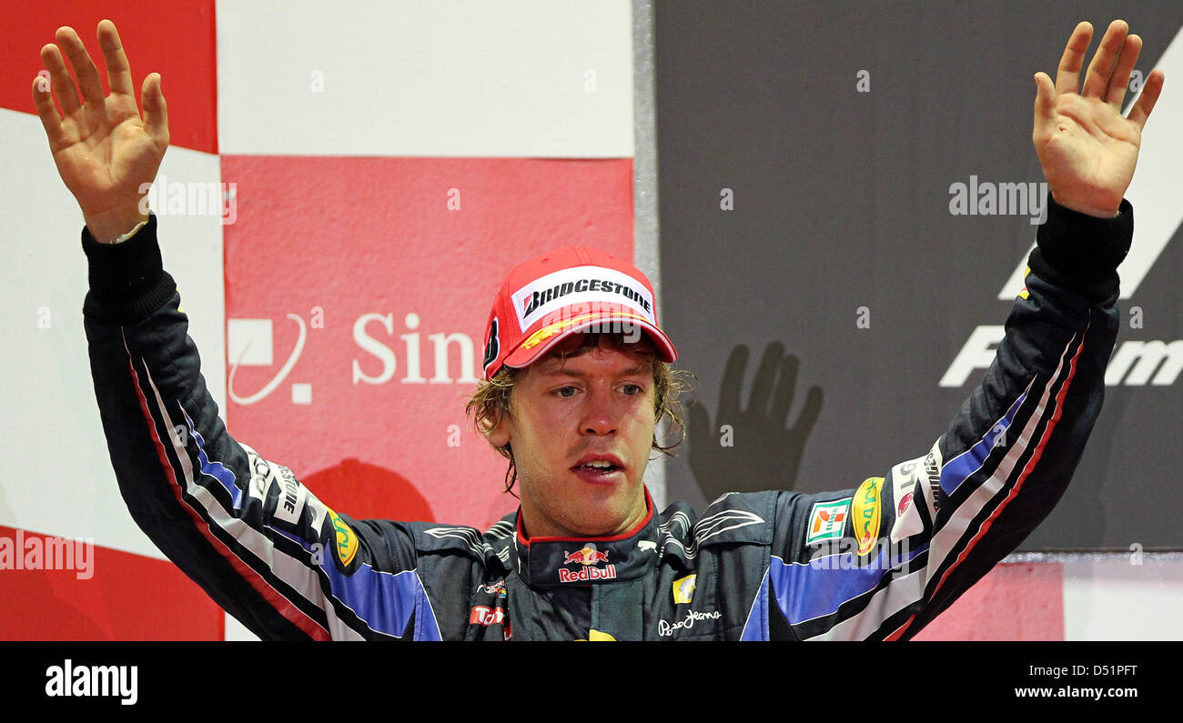 German driver Sebastian Vettel of Red Bull cheers at the award ceremony ...