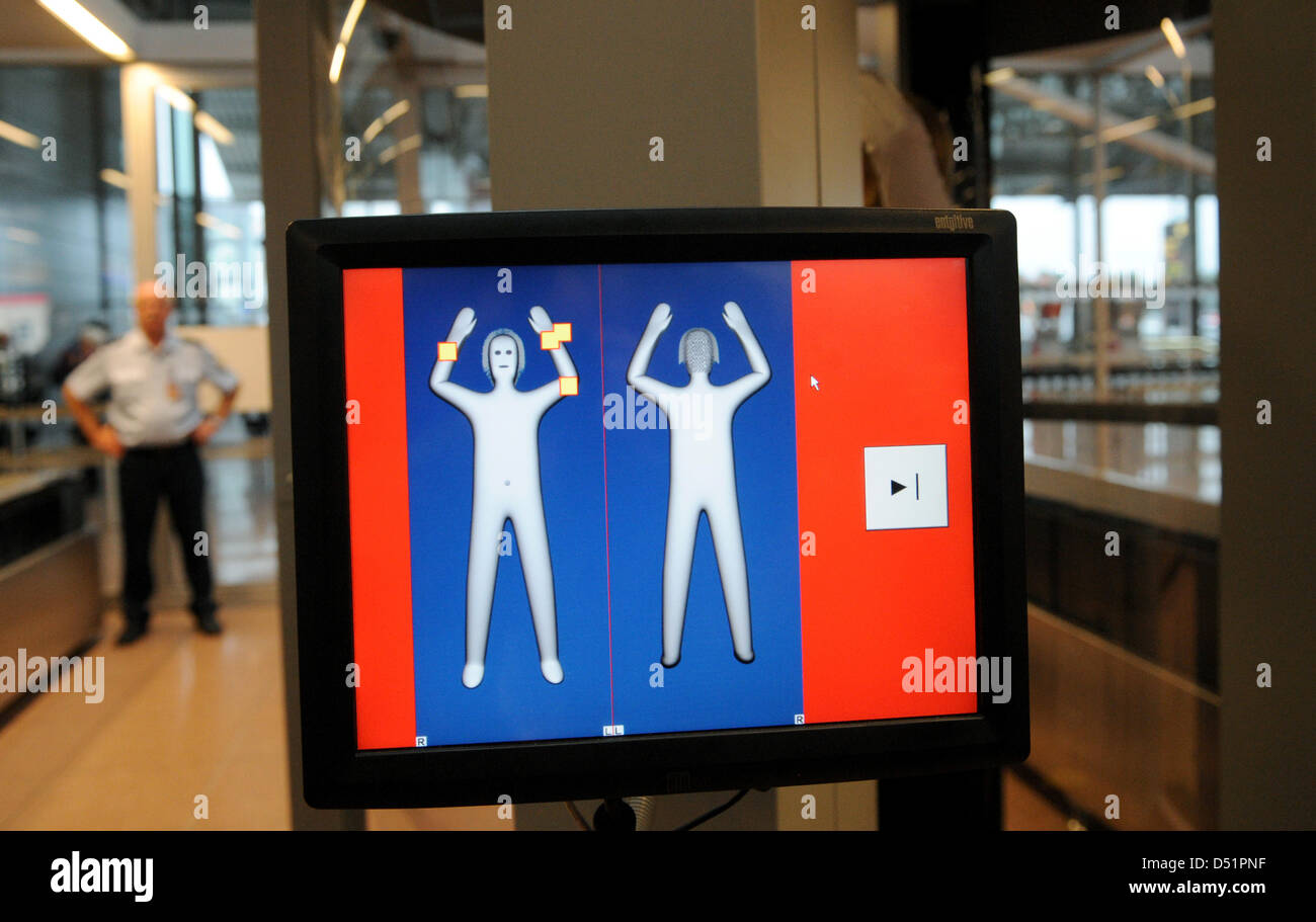 A womans stands inside a body scanner at the airport in Hamburg ...