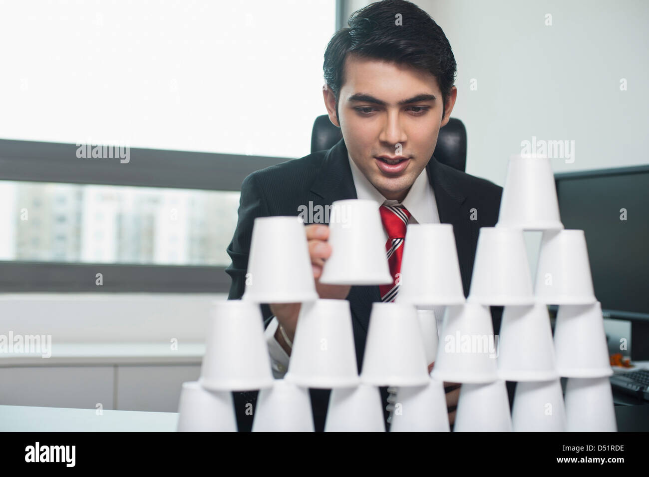 Businessman Making A Pyramid With Disposable Cups Stock Photo Alamy businessman-making-a-pyramid-with-disposable-cups-stock-photo-alamy