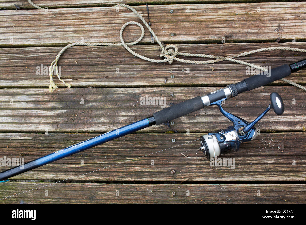 Fishing rod on wooden decking Stock Photo - Alamy