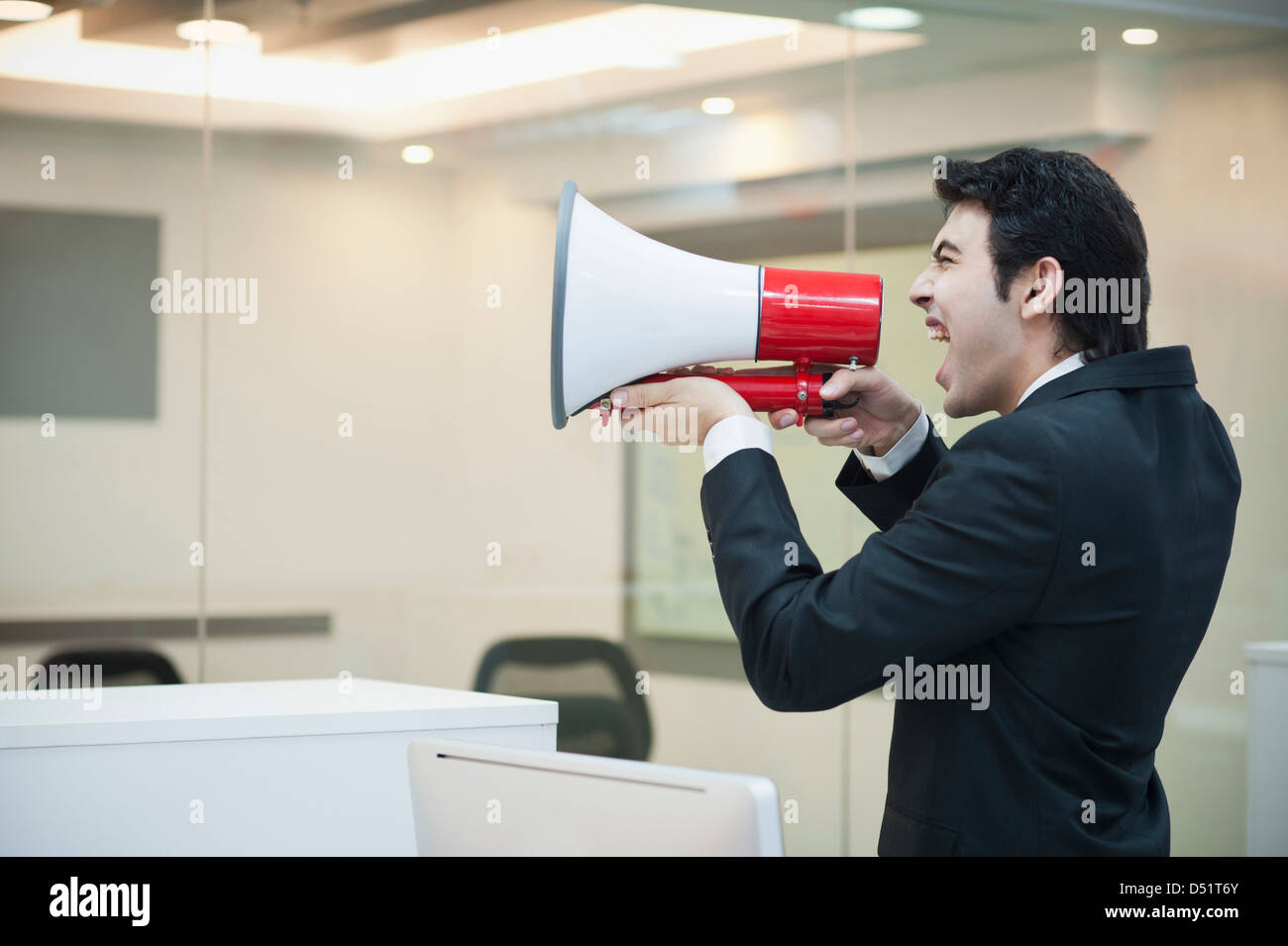 Businessman shouting into a bullhorn Stock Photo - Alamy