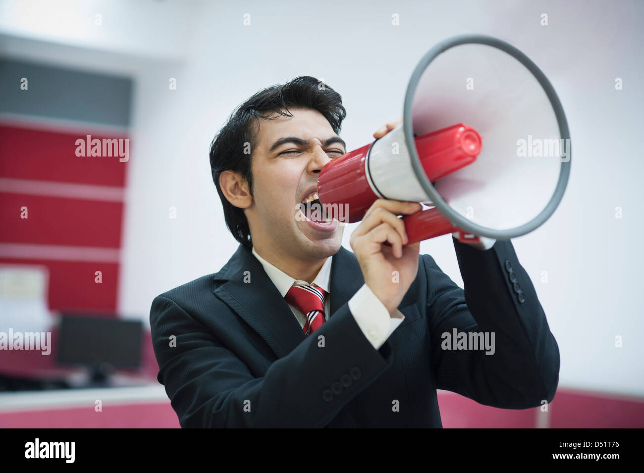 Businessman shouting into a bullhorn Stock Photo - Alamy
