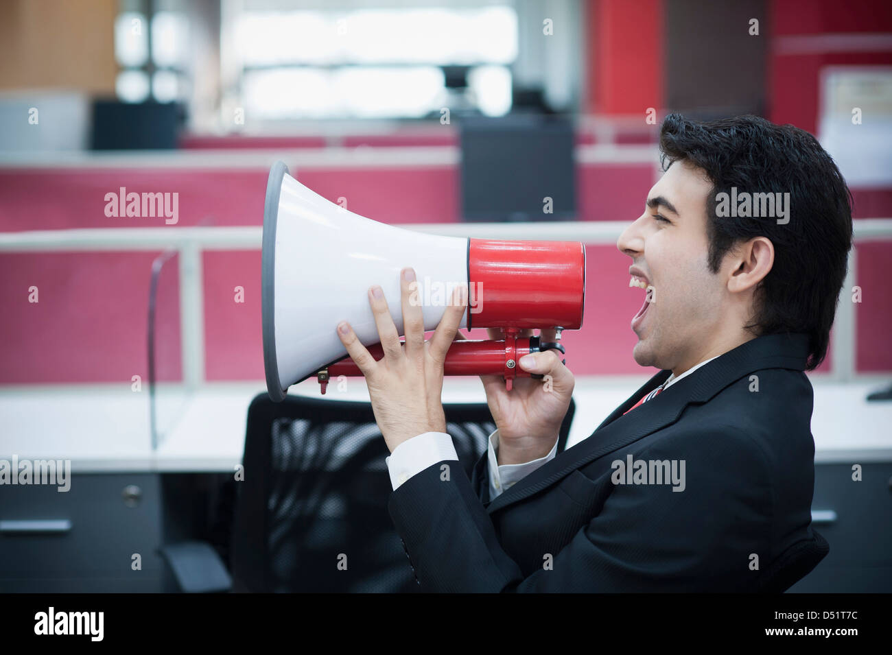 Businessman shouting into a bullhorn Stock Photo - Alamy