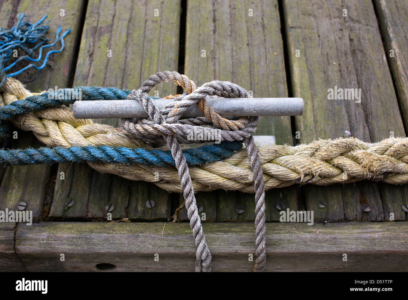 old rope on wooden decking Stock Photo - Alamy