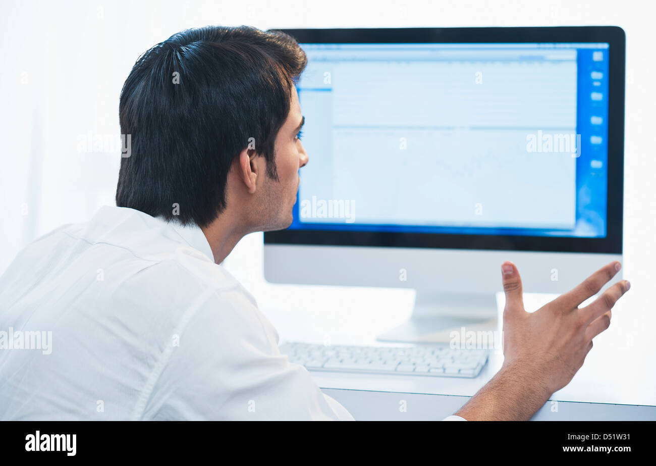 Businessman looking at a computer Stock Photo - Alamy