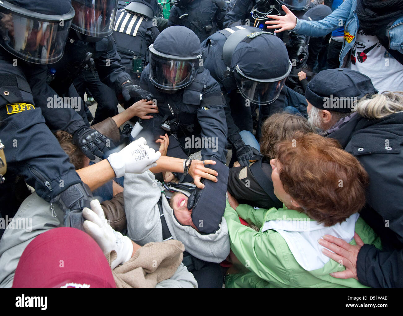 Police forces in riot gear take on people protesting against heavily ...