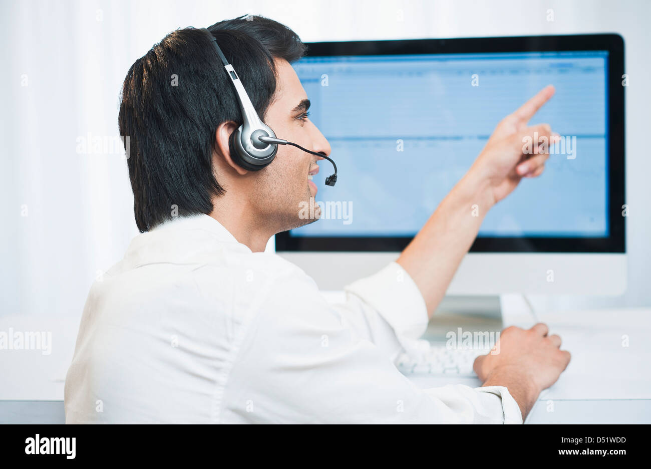 Customer service representative wearing a headset Stock Photo - Alamy