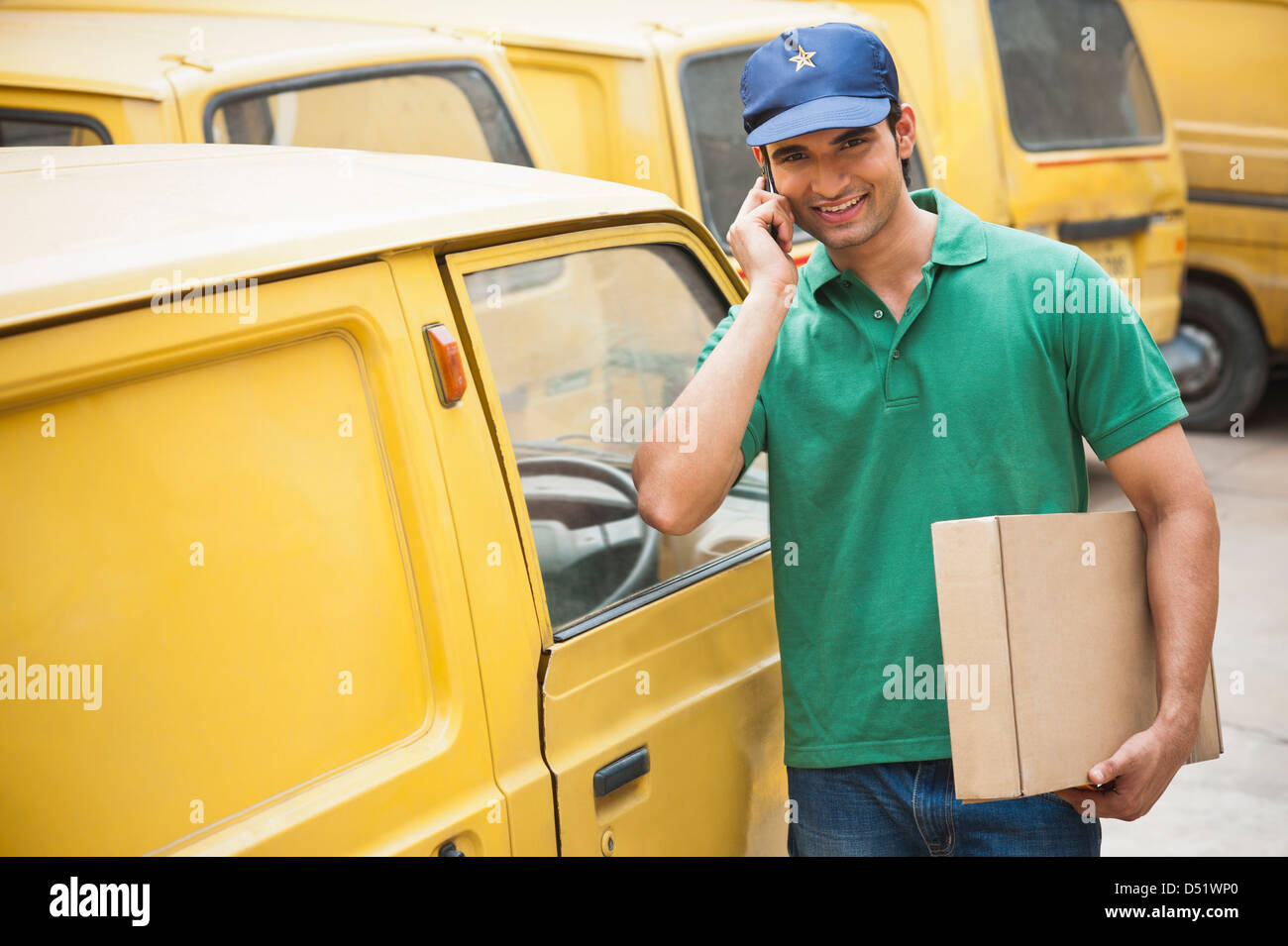 Delivery man talking on a mobile phone Stock Photo - Alamy
