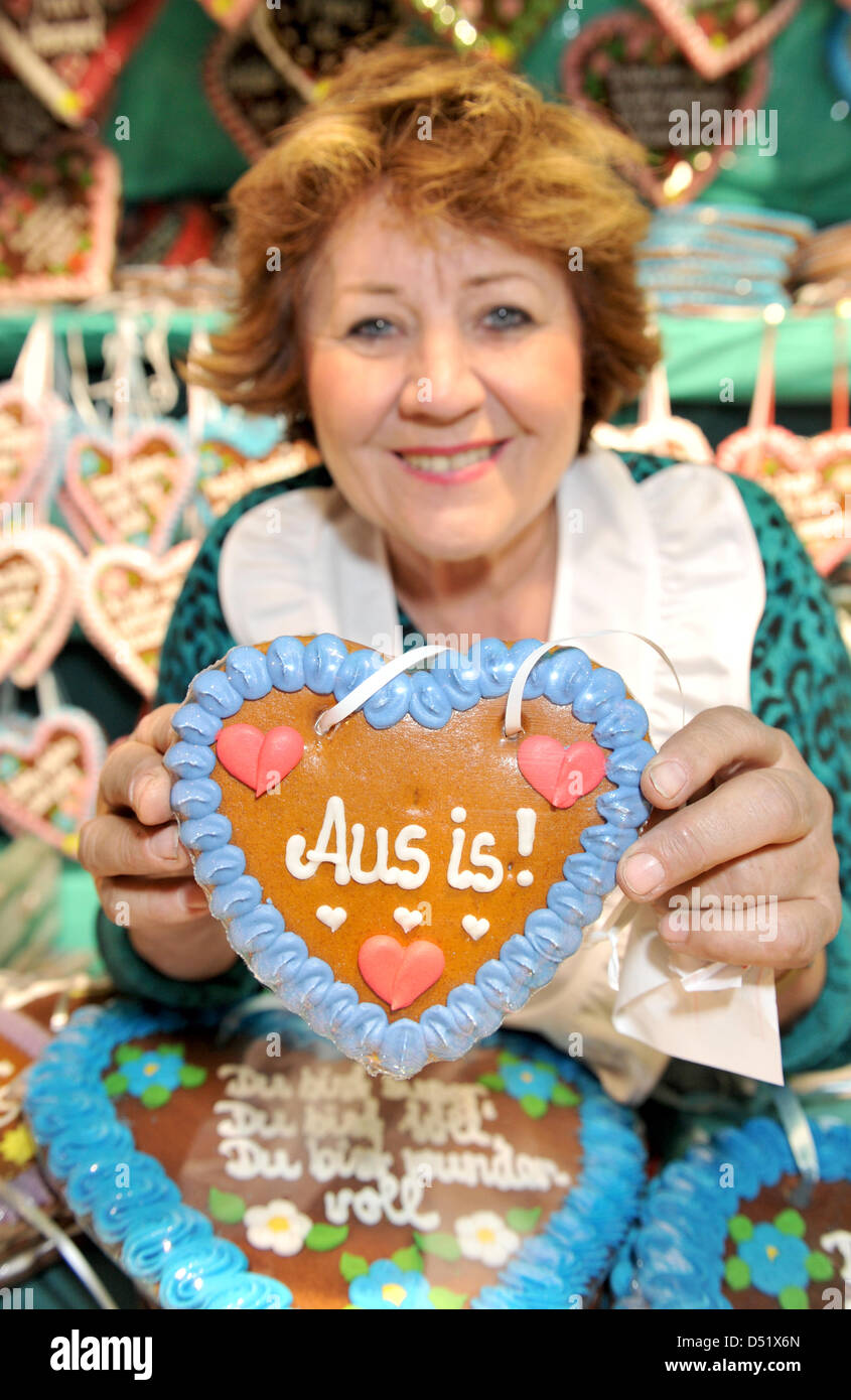 Sweet shop owner Christl Reitz poses for a picture with a candy heart ...