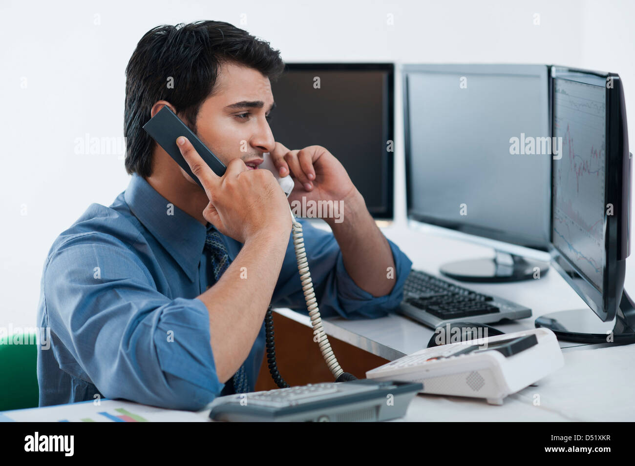 Businessman talking on a landline phones Stock Photo - Alamy
