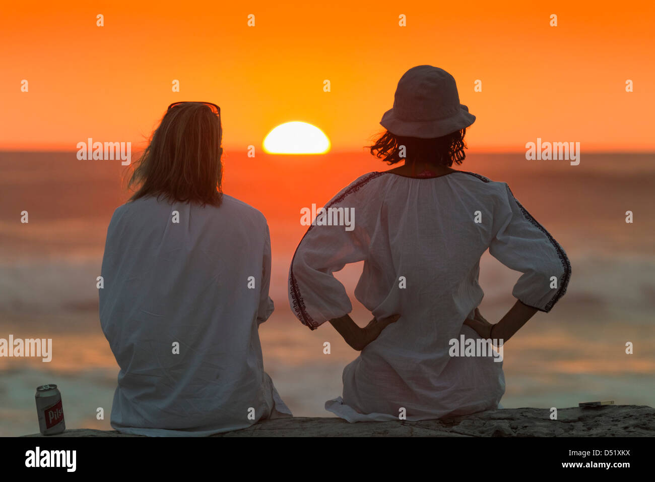 Women enjoying sunset on popular Playa Guiones surf beach, Nosara ...