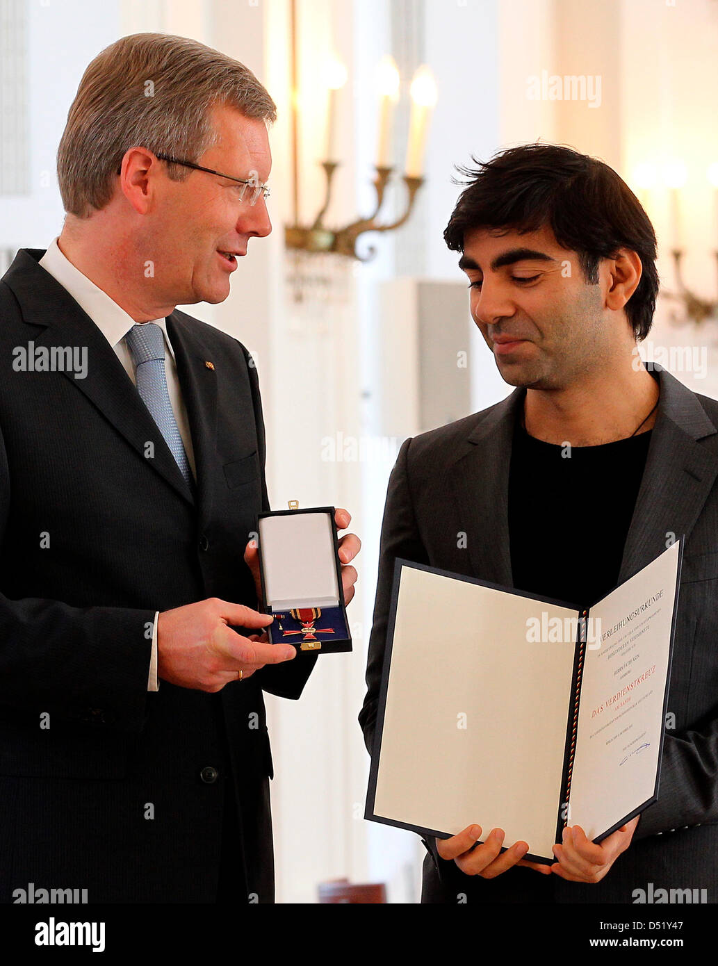 German President Christian Wulff presents director Fatih Akin with the ...