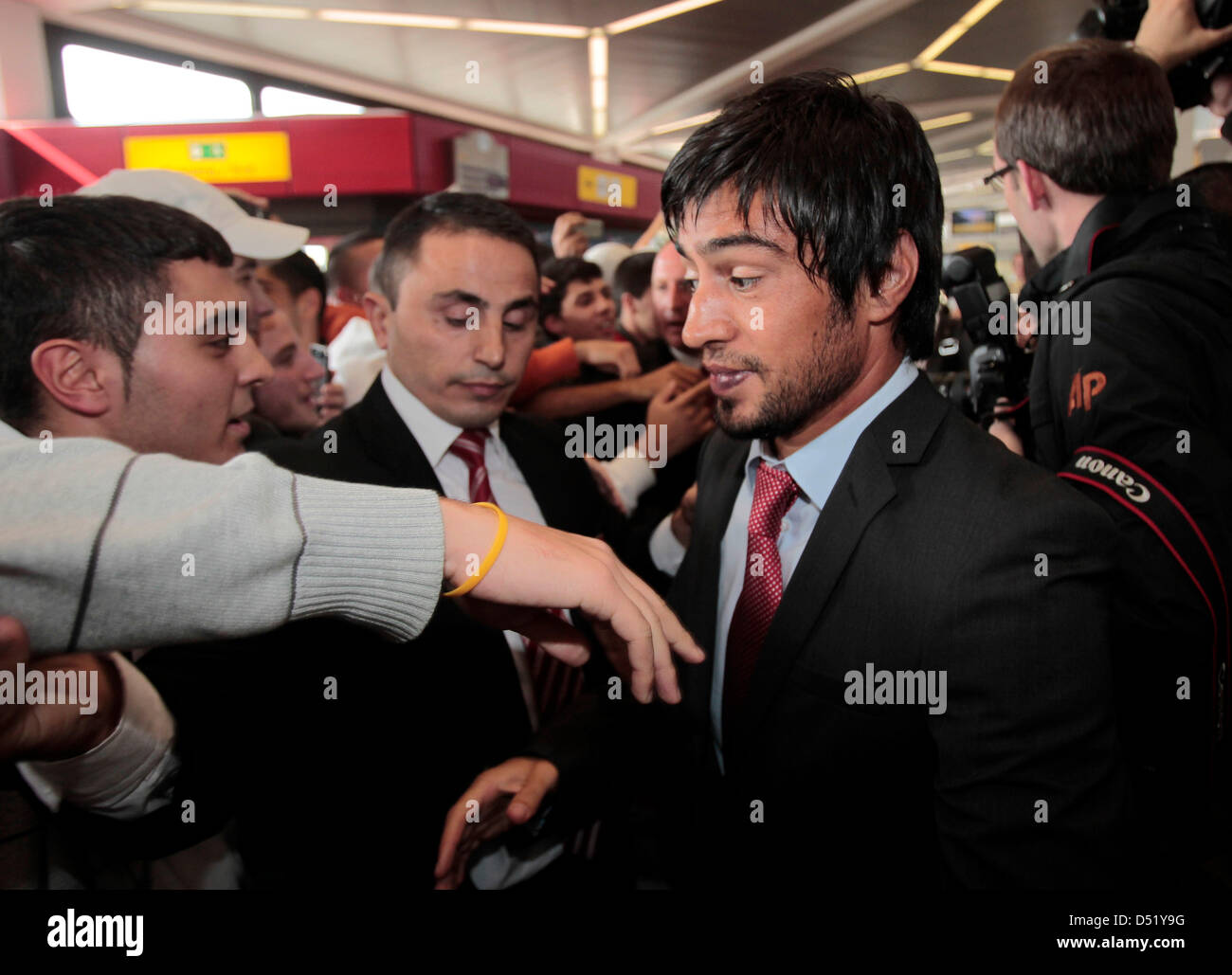 Turkish national team player Ibrahim Toraman is greeted by fans at ...