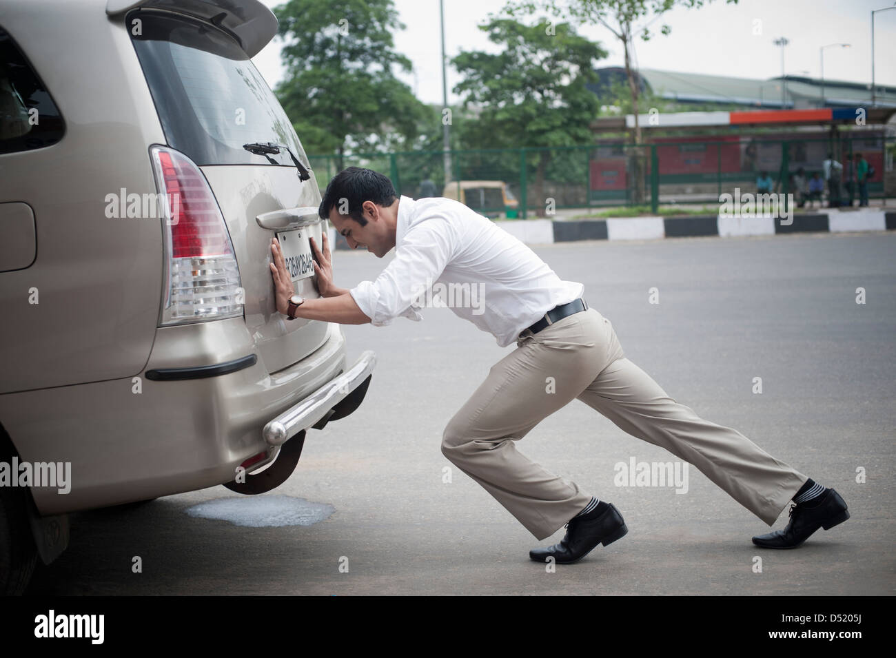 People pushing car down road hi-res stock photography and images - Alamy