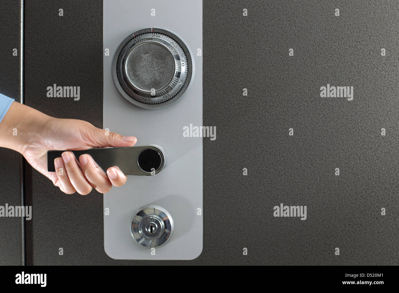 Hand opening a large safe Stock Photo - Alamy
