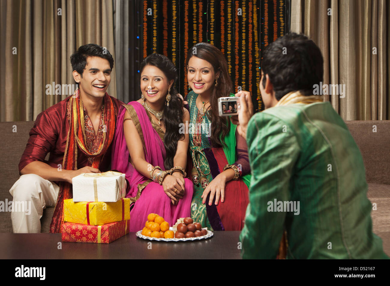 Man taking a picture of his friends with a camera on Diwali Stock Photo ...