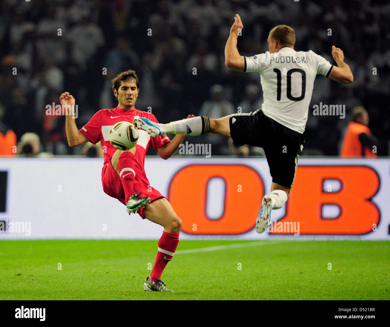 German player Lukas Podolski (R) and Turkish player Halil Altintop vie ...