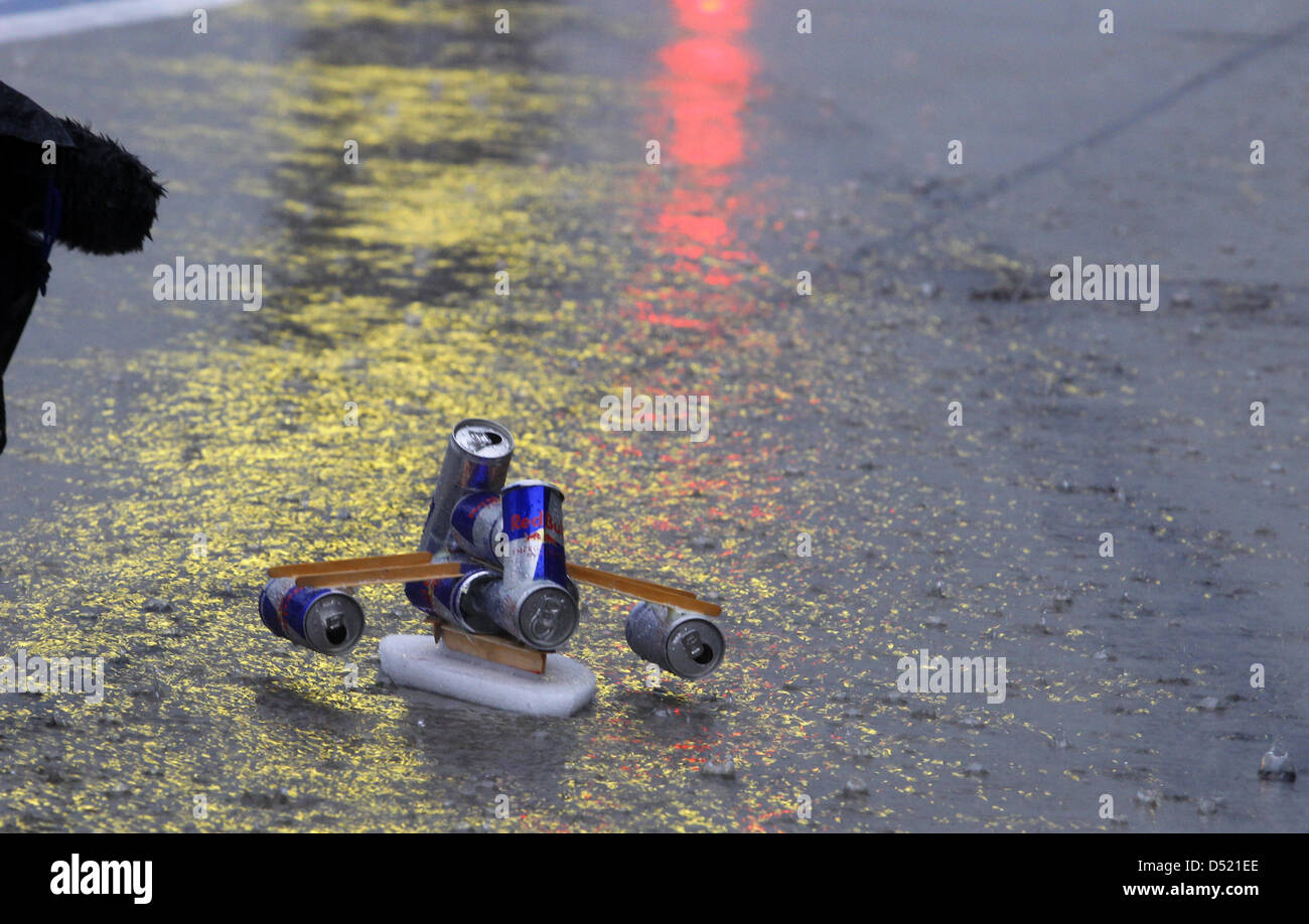A self-made boat, built by a mechanic of Team Red Bull, floats down a ...