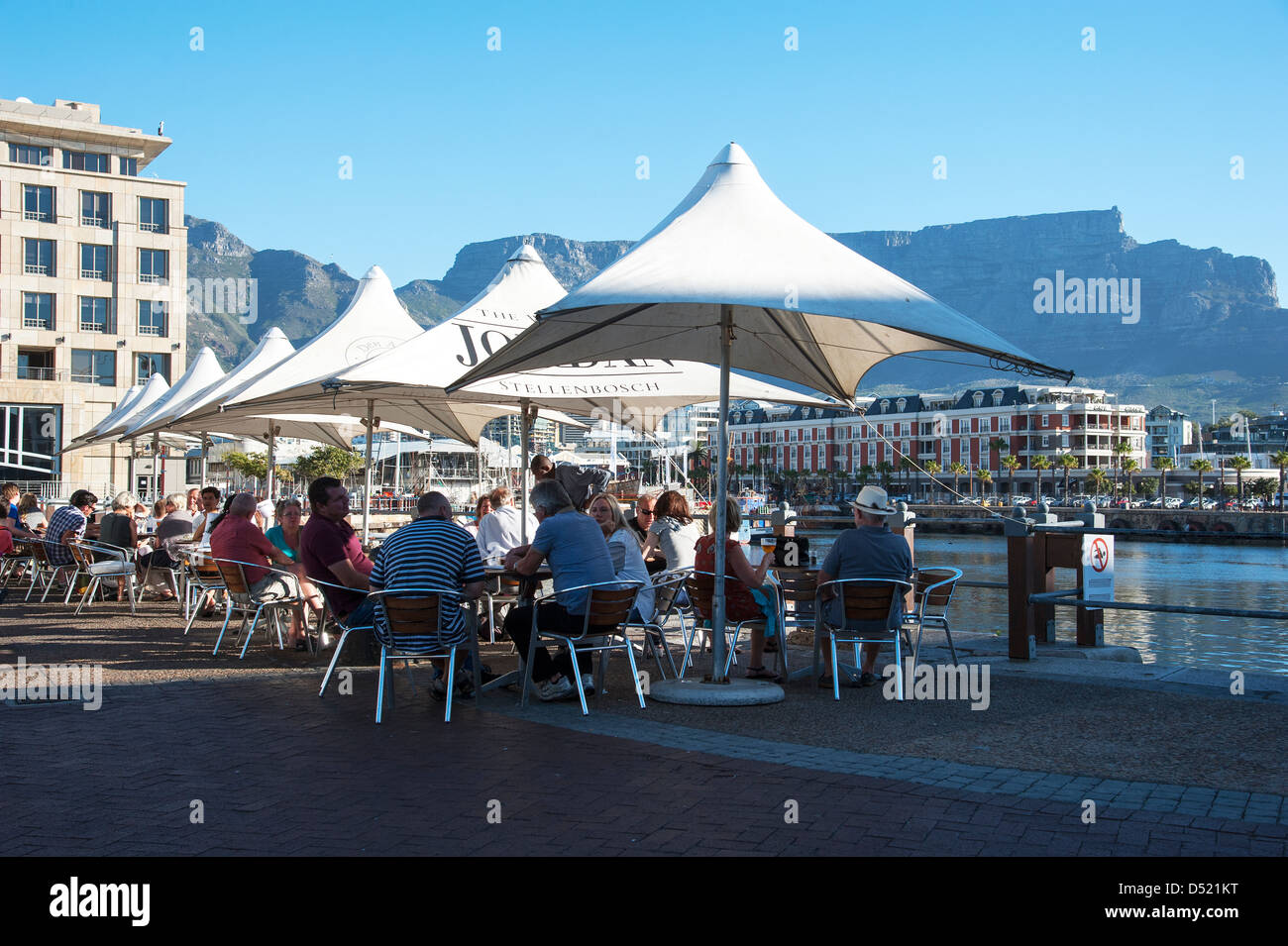 V&A Waterfront Cape Town & Table Mountain. Tourists at cafe tables ...