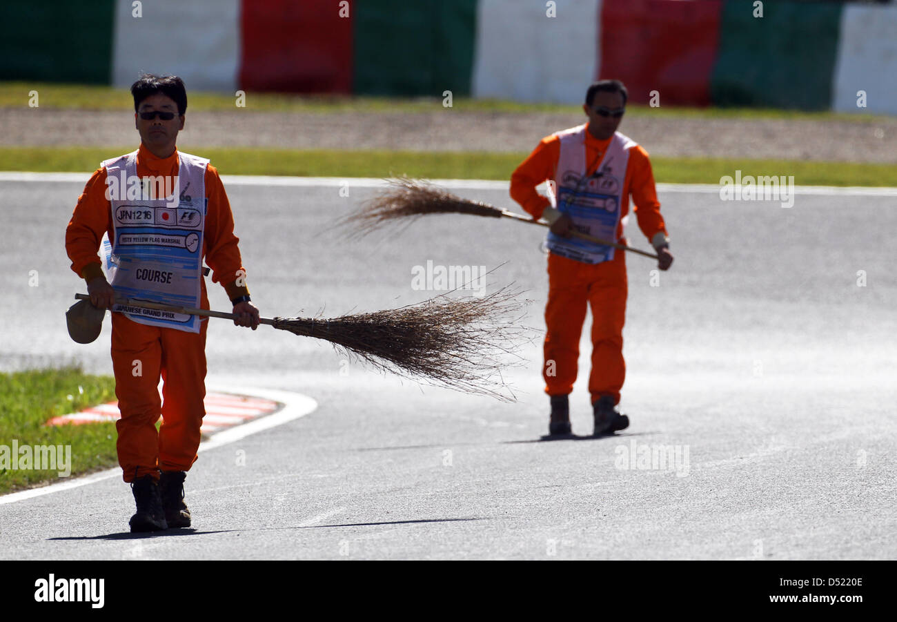 A team of motorsports marshals clear the racetrack equippped with ...