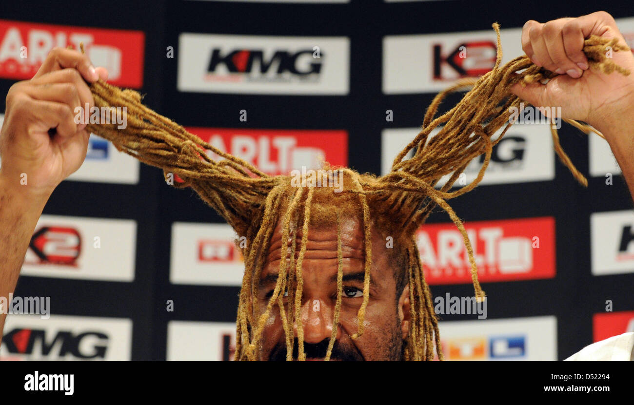 US heavyweight boxer Shannon Briggs holds up strands of his braided ...