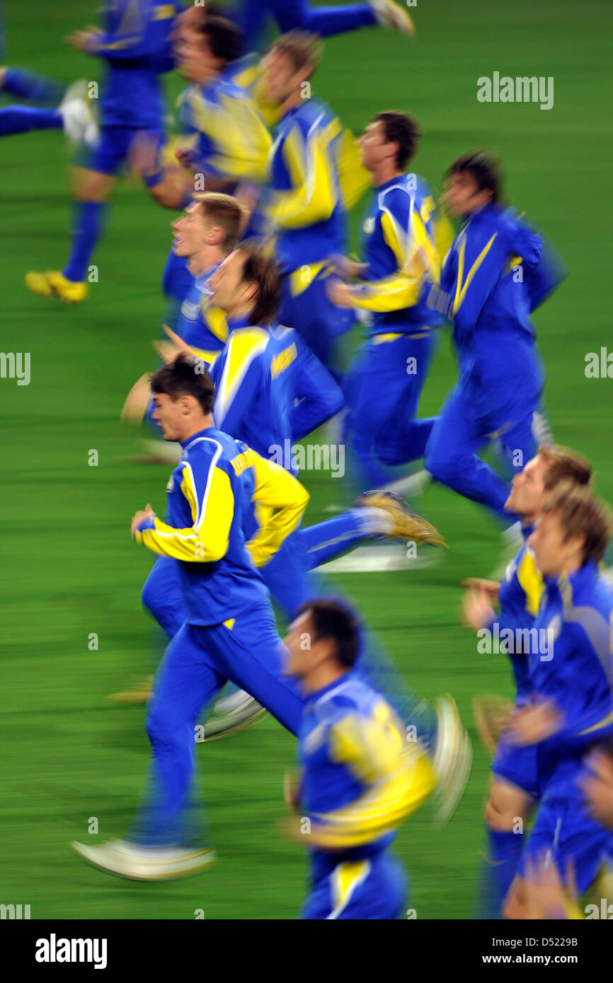 The players of the Kazakh national soccer team run during their final ...