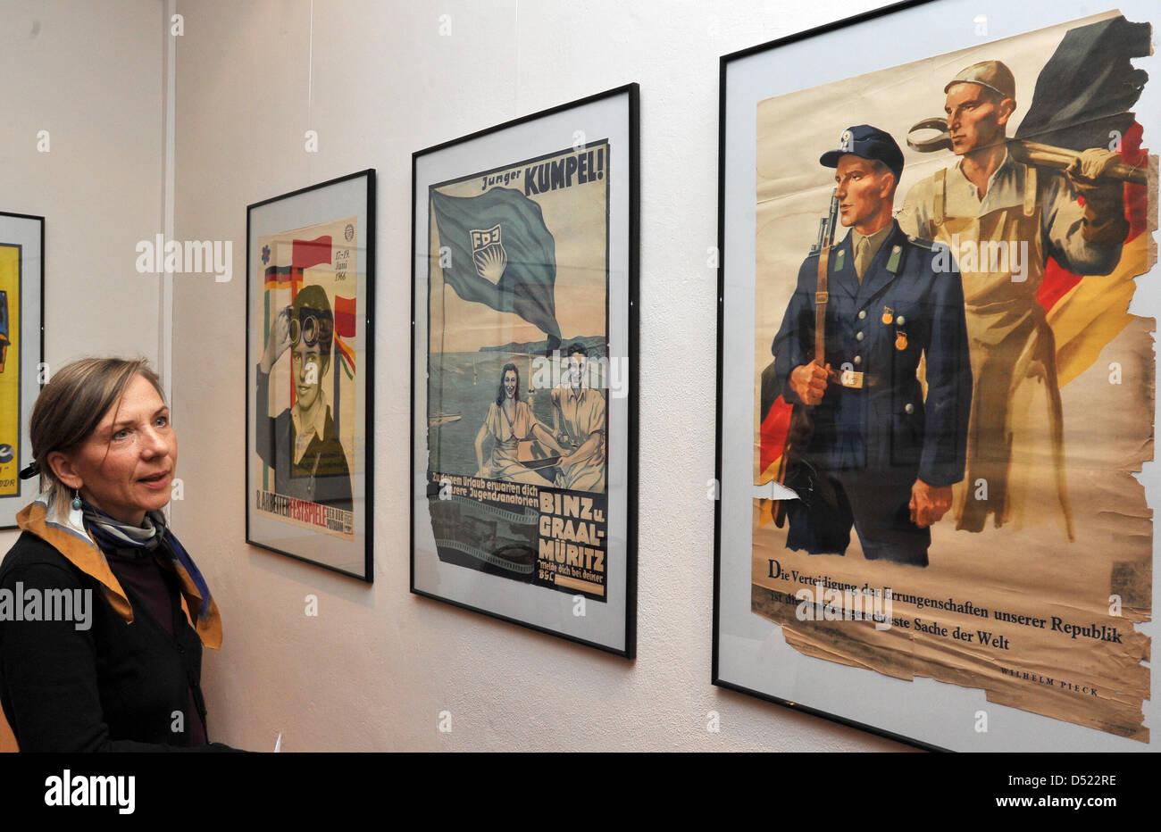 A woman eyes GDR propaganda posters on display in an exhibition at ...
