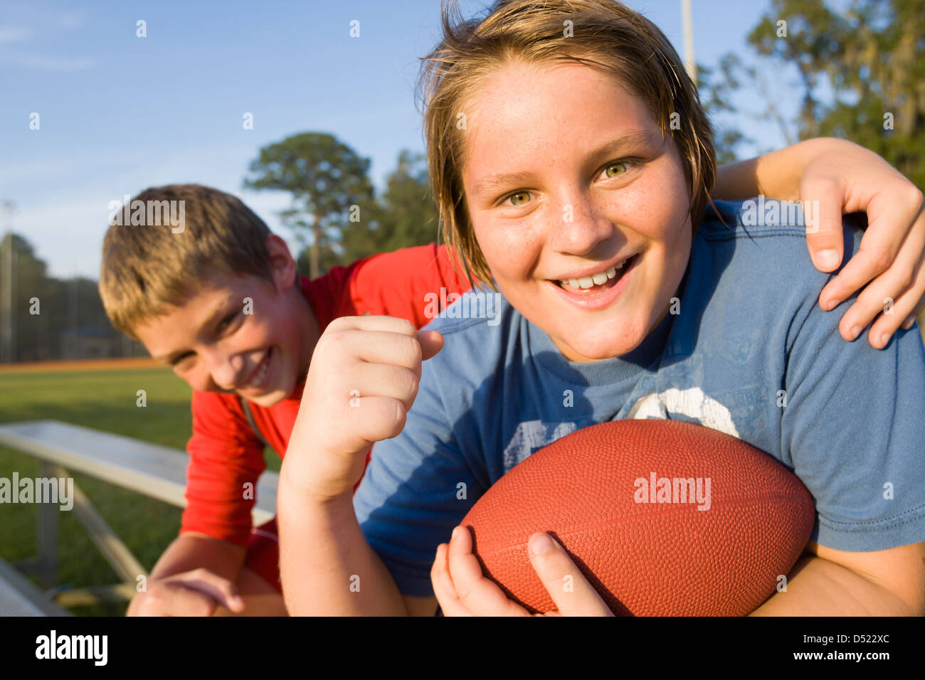 Two boys sitting bench sports field hi-res stock photography and images ...