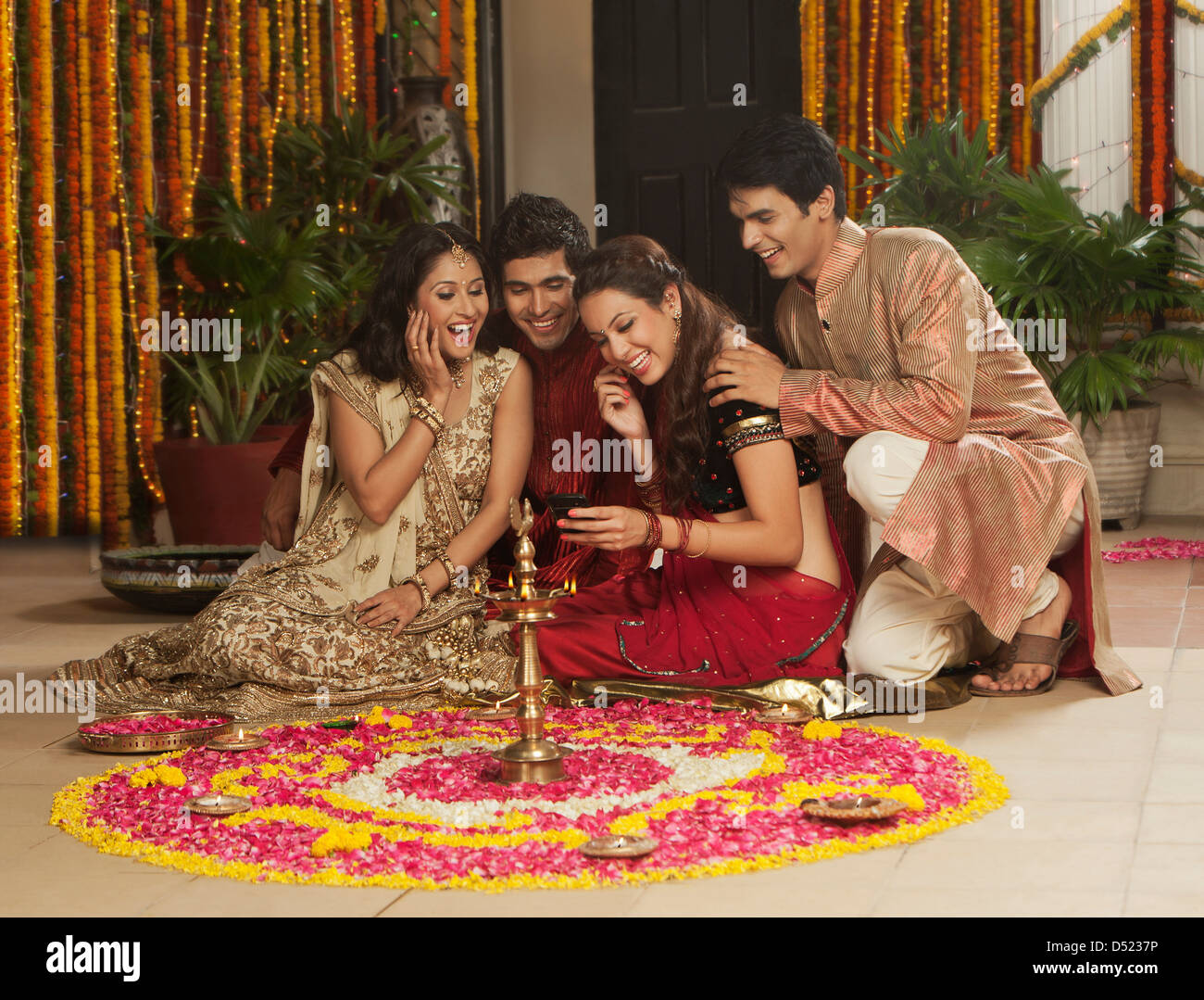 Friends text messaging on a mobile phone on Diwali Stock Photo - Alamy Friends text messaging on a mobile phone on Diwali Stock Photo - Alamy