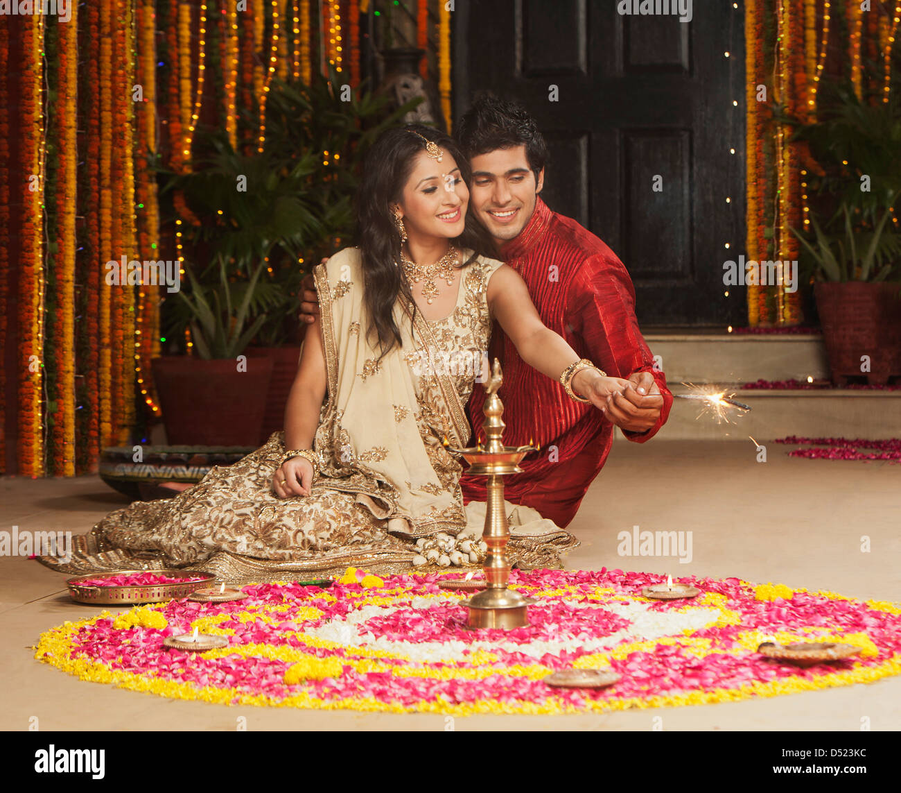Couple burning fire crackers on Diwali Stock Photo - Alamy