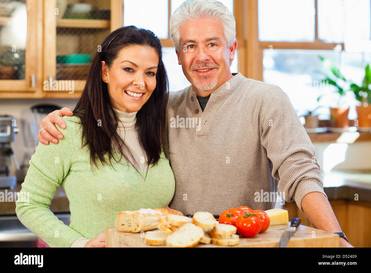 Hispanic couple cooking together in kitchen Stock Photo - Alamy