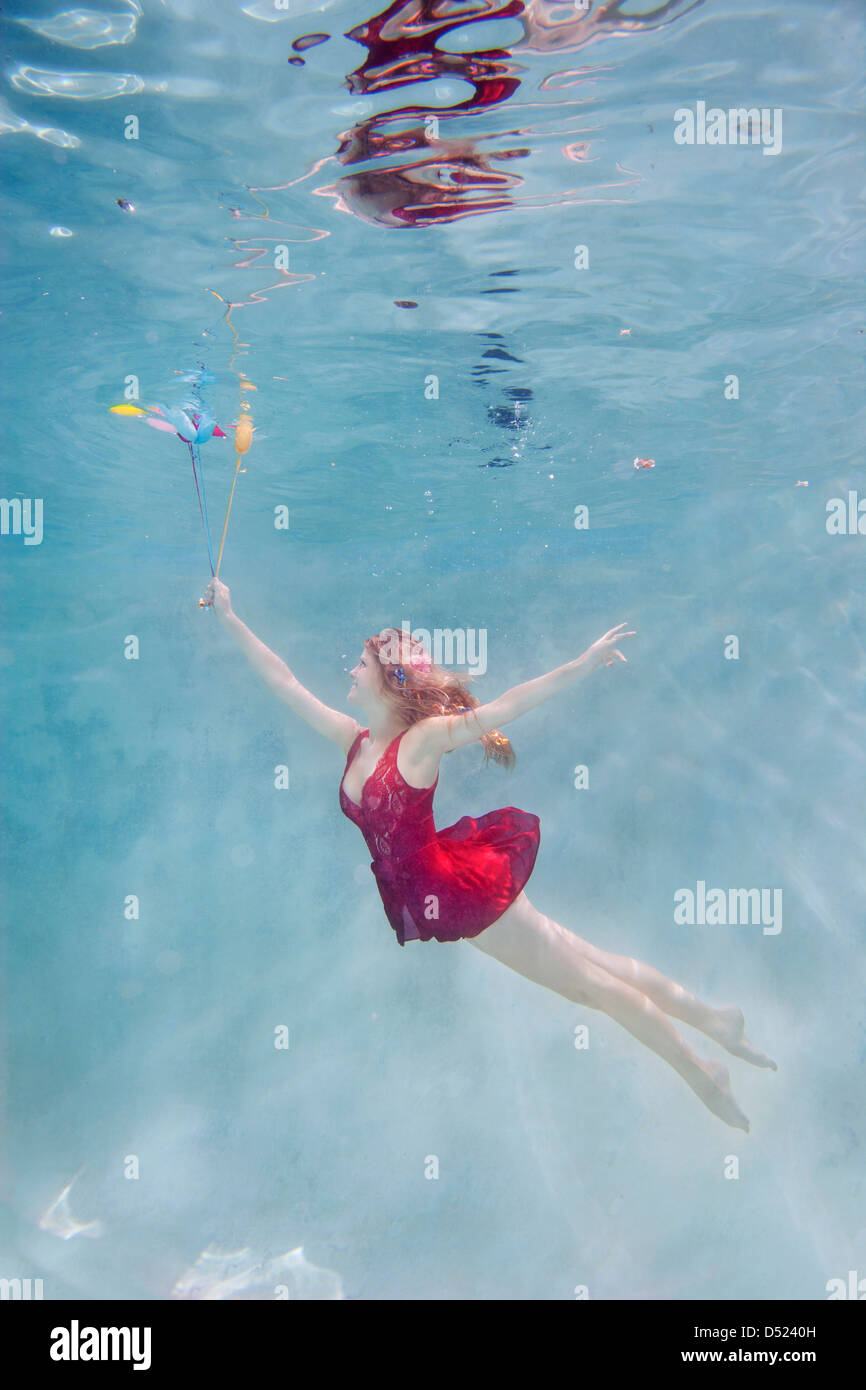 Caucasian woman with balloons underwater Stock Photo - Alamy